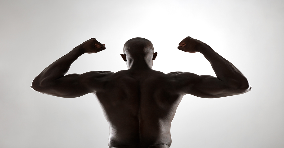 Muscular man’s back in silhouette | Conjunctio