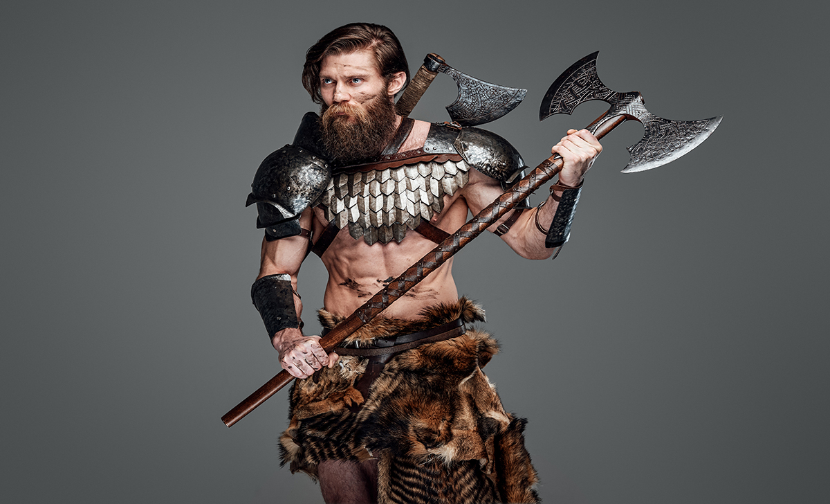 Proud viking with two axes and grimy face prepared to fight | Conjunctio